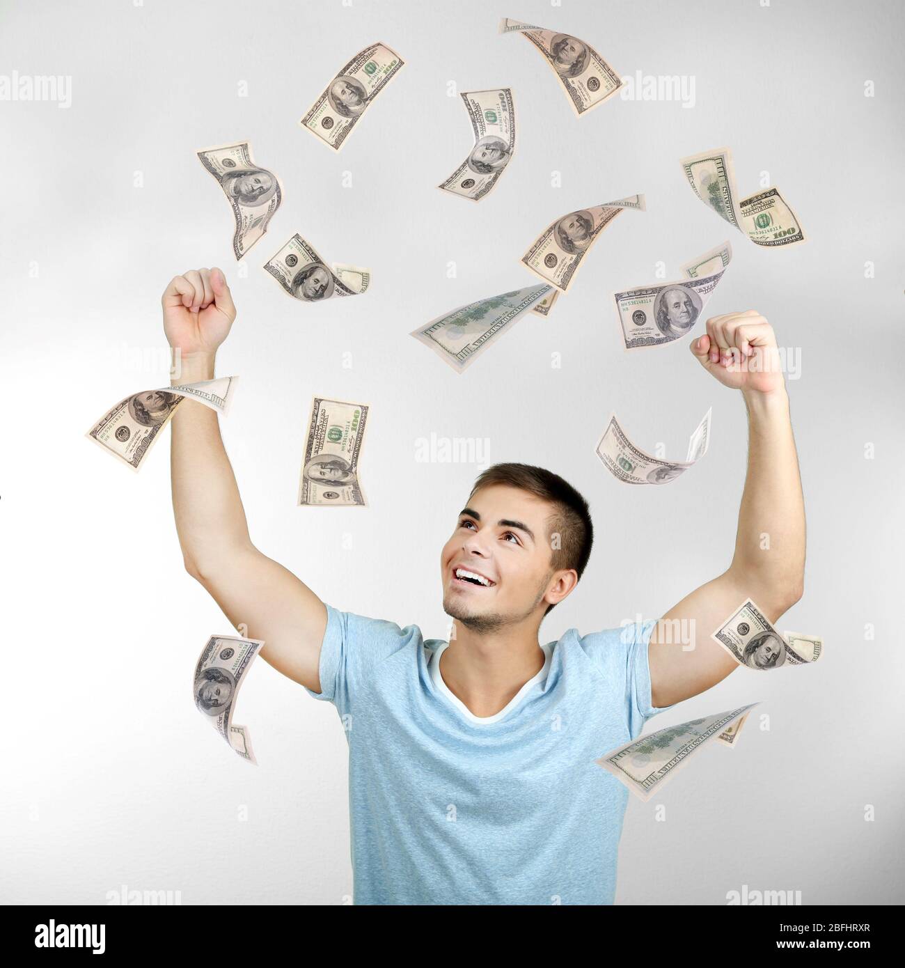 Happy man enjoying rain of money Stock Photo - Alamy