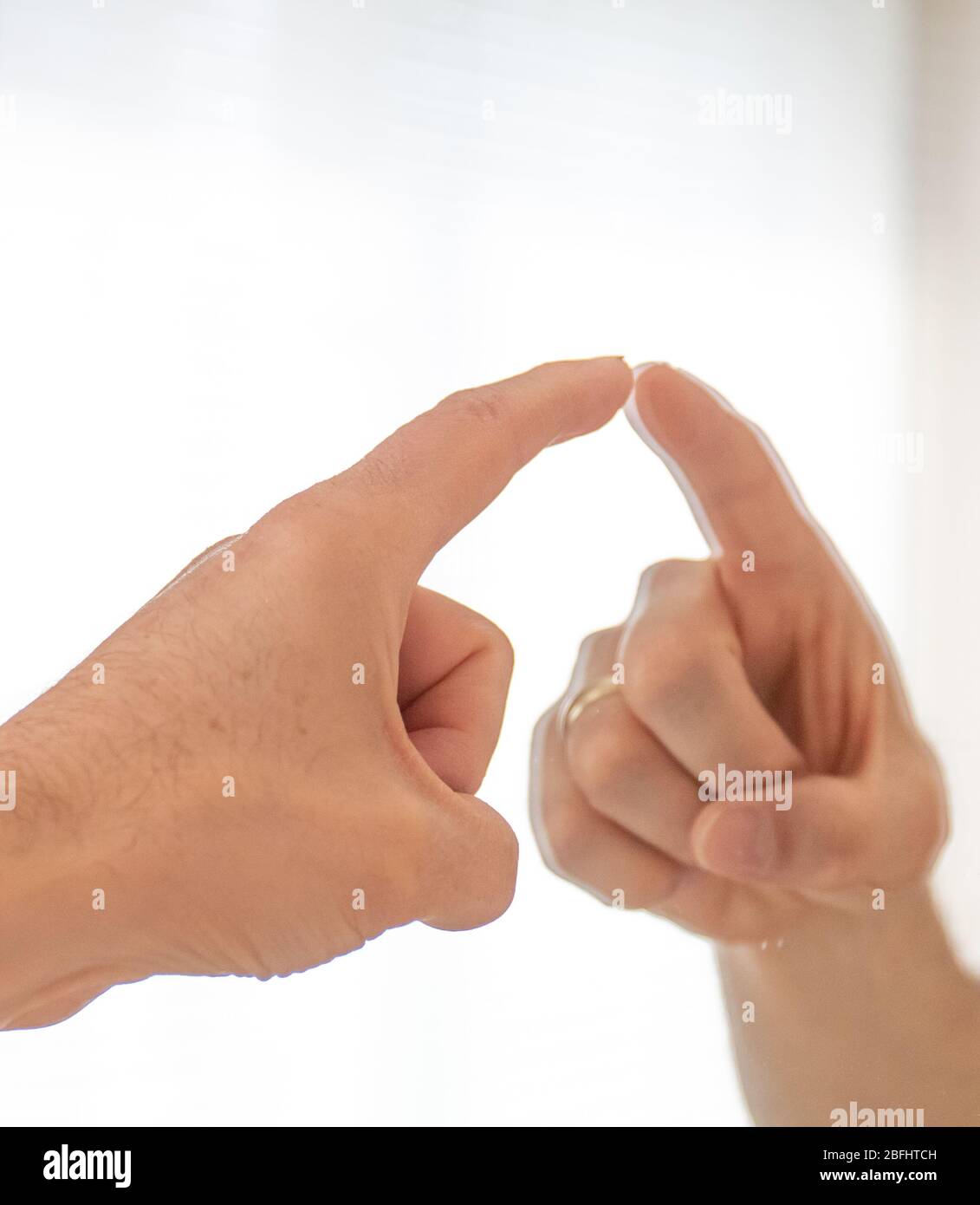 white hand touching itself in a mirror showing reflection Stock Photo ...