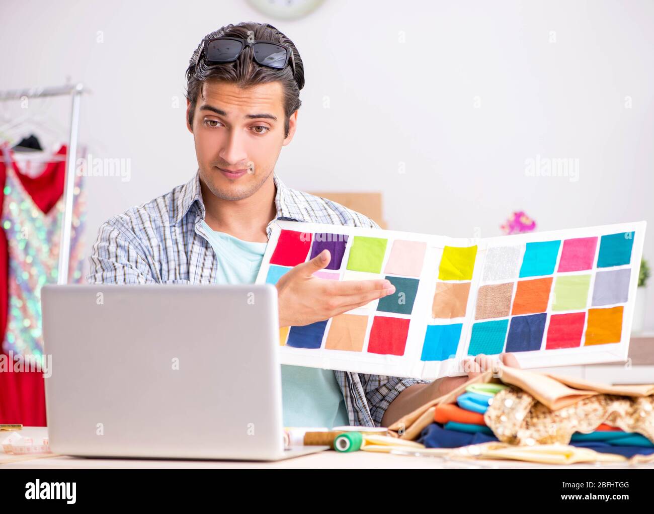 The young handsome tailor working in his workshop Stock Photo - Alamy