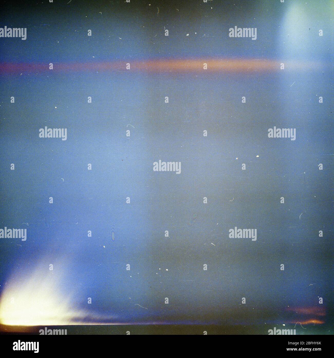 Noisy blue film frame with scratches, dust and light leak. Abstract old ...