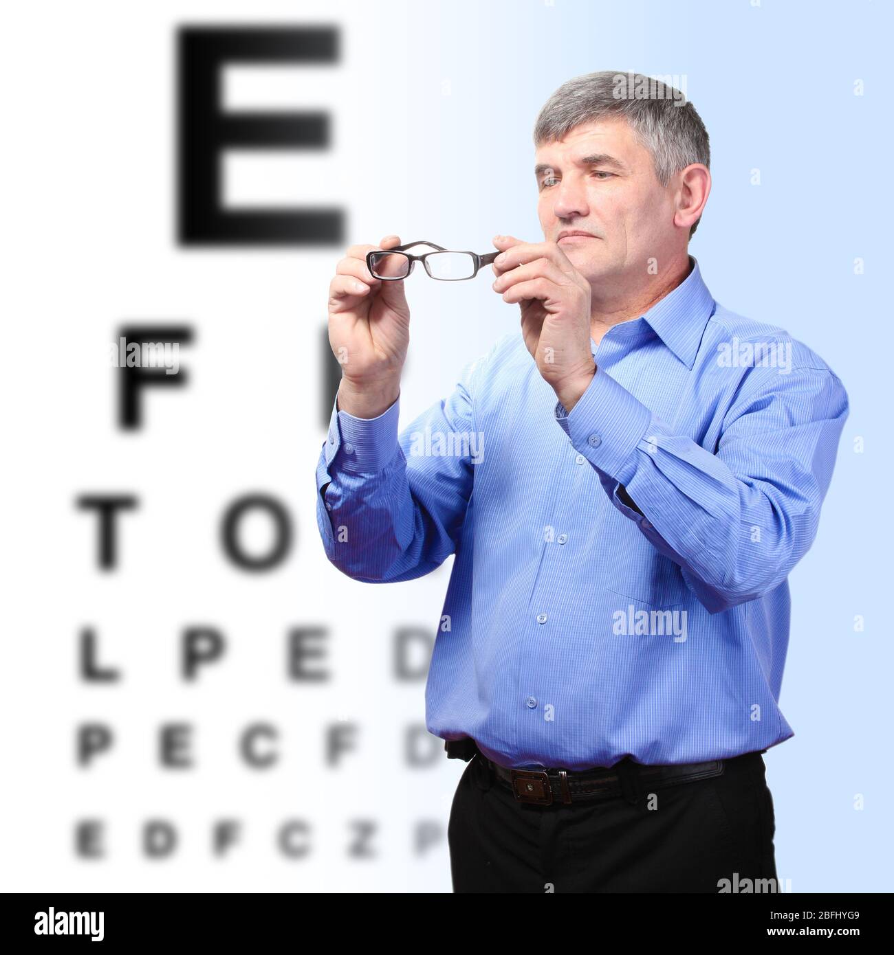 Medicine and vision concept - man with eye chart Stock Photo - Alamy