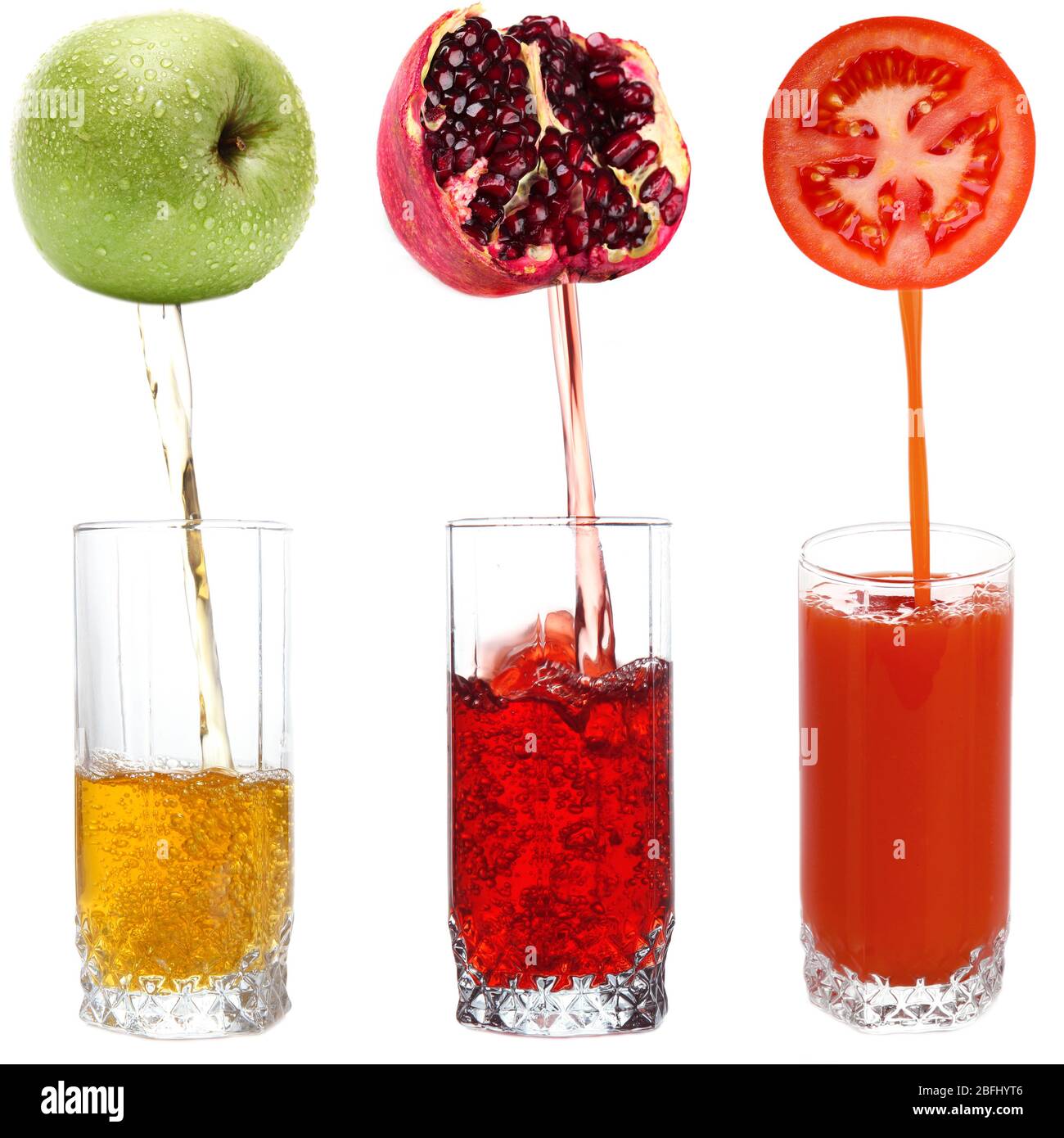 Juice pouring from fruits and vegetables into glass, isolated on white ...