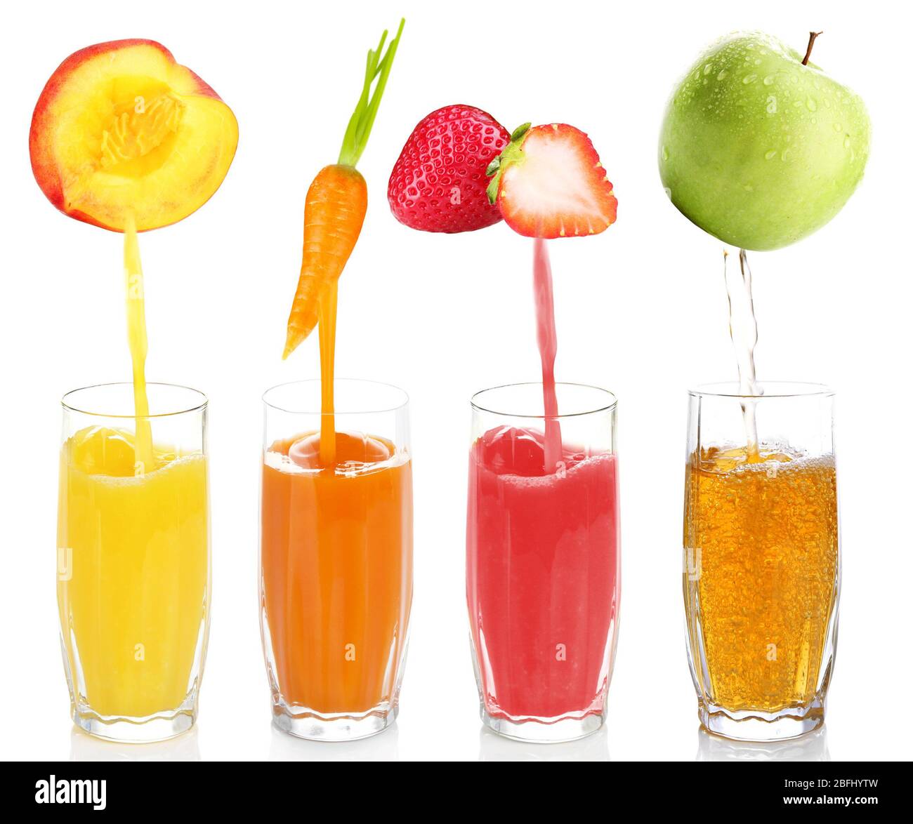 Juice pouring from fruits and vegetables into glass, isolated on white ...