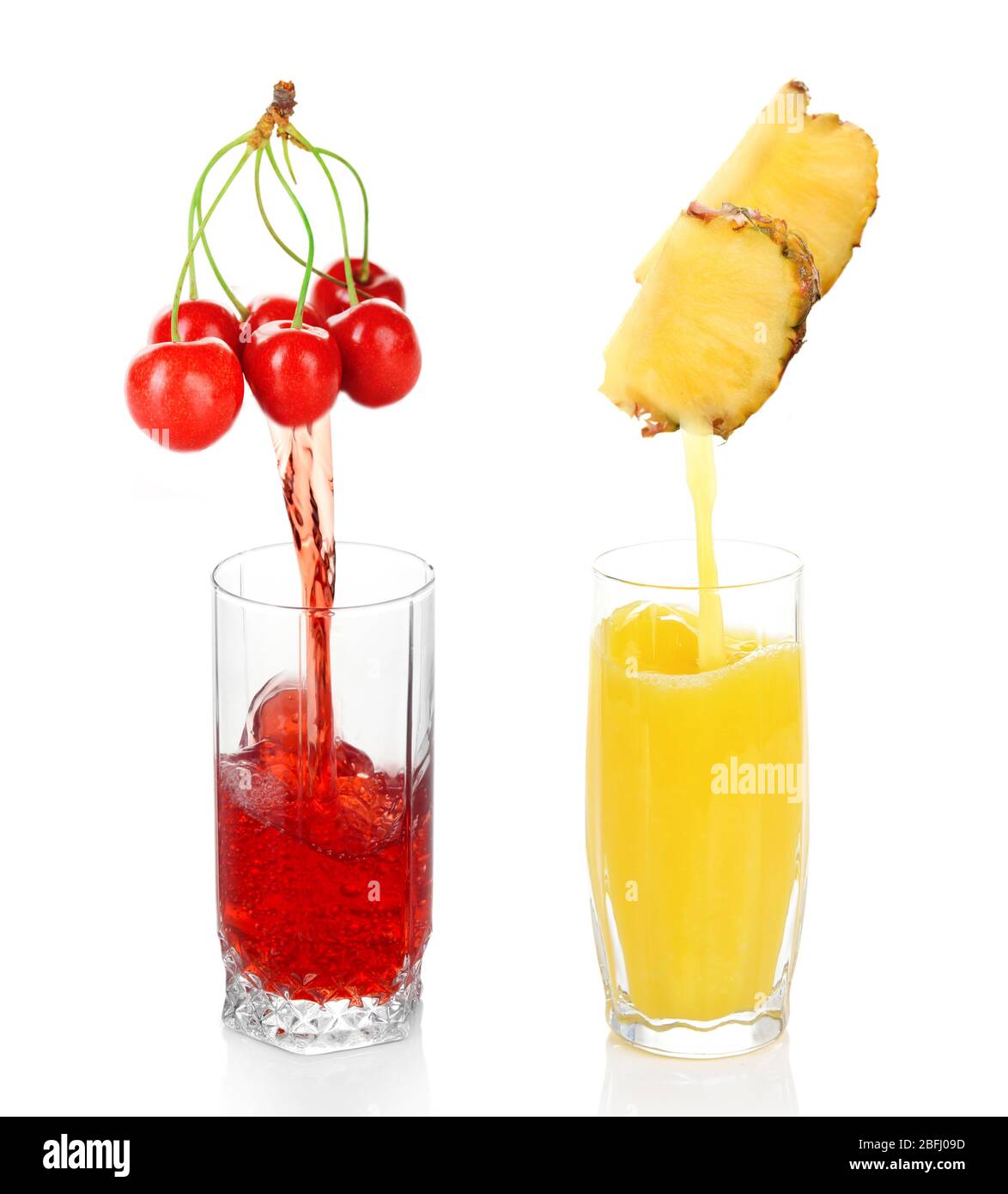 Juice pouring from fruits into glass, isolated on white Stock Photo - Alamy