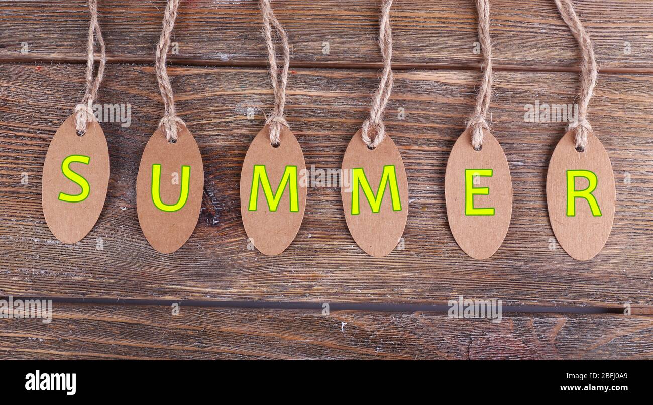 Summer tags on wooden background Stock Photo - Alamy