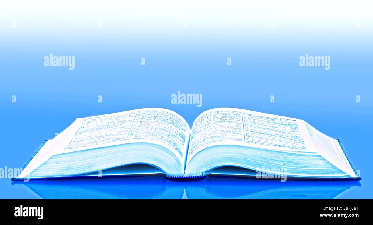 Open book on blue background Stock Photo - Alamy