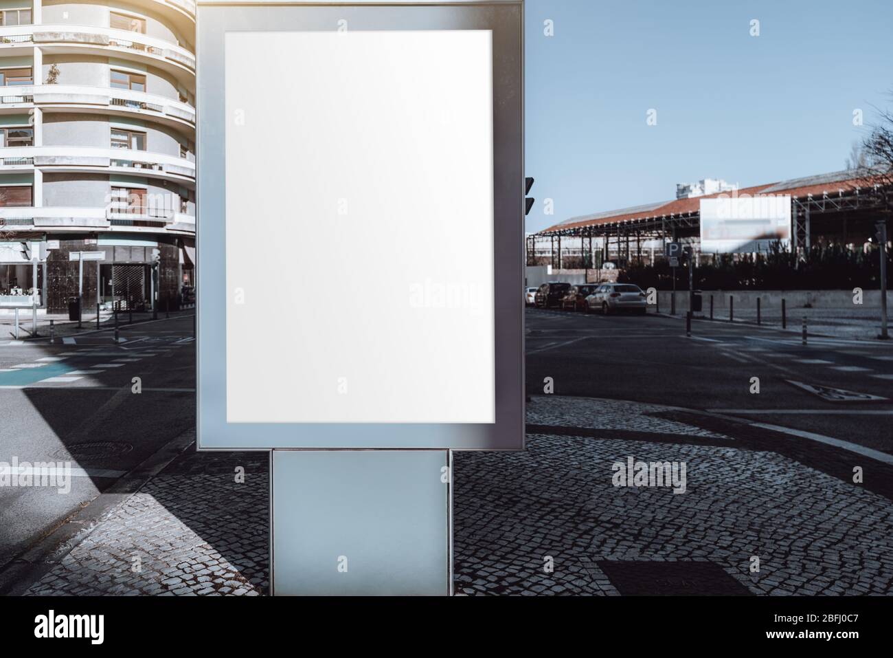 Mockup of an empty ad billboard in urban settings near a road junction ...