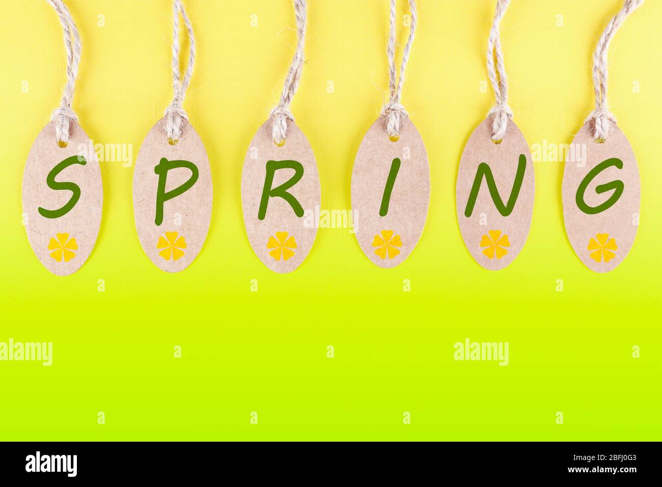 Spring tags on bright background Stock Photo - Alamy