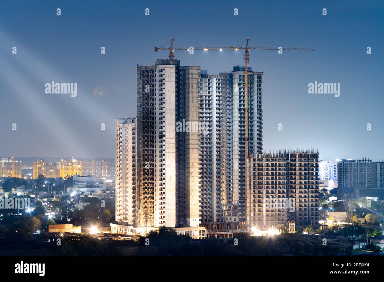 aerial shot of under construction buildings with two beams of light ...