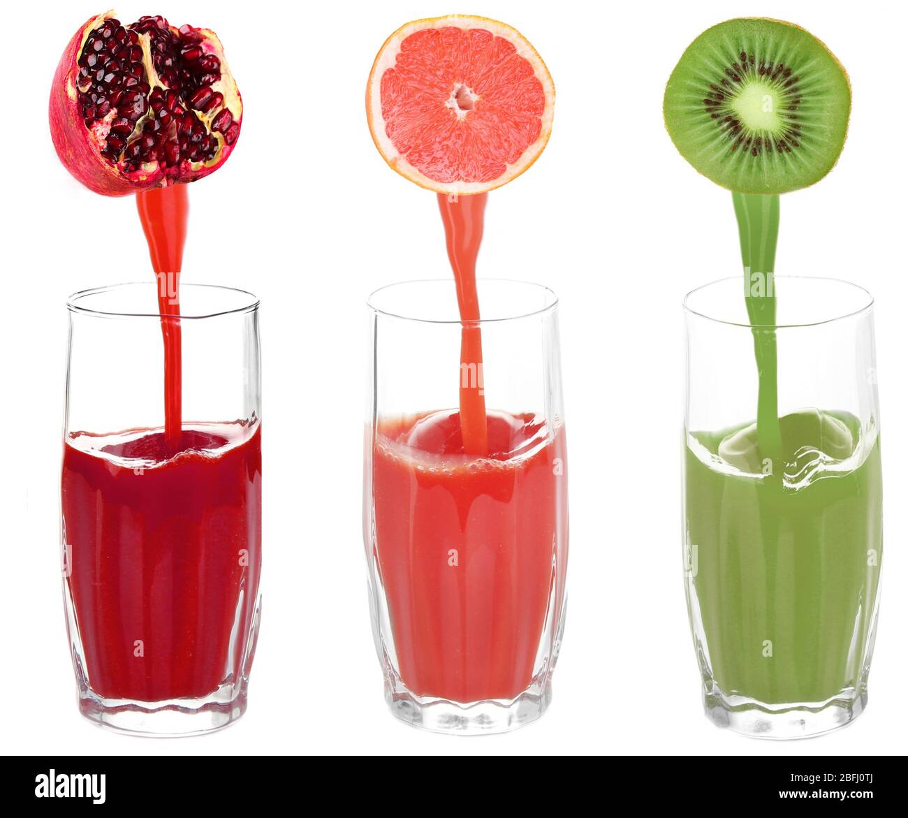 Juice pouring from fruits into glass, isolated on white Stock Photo - Alamy