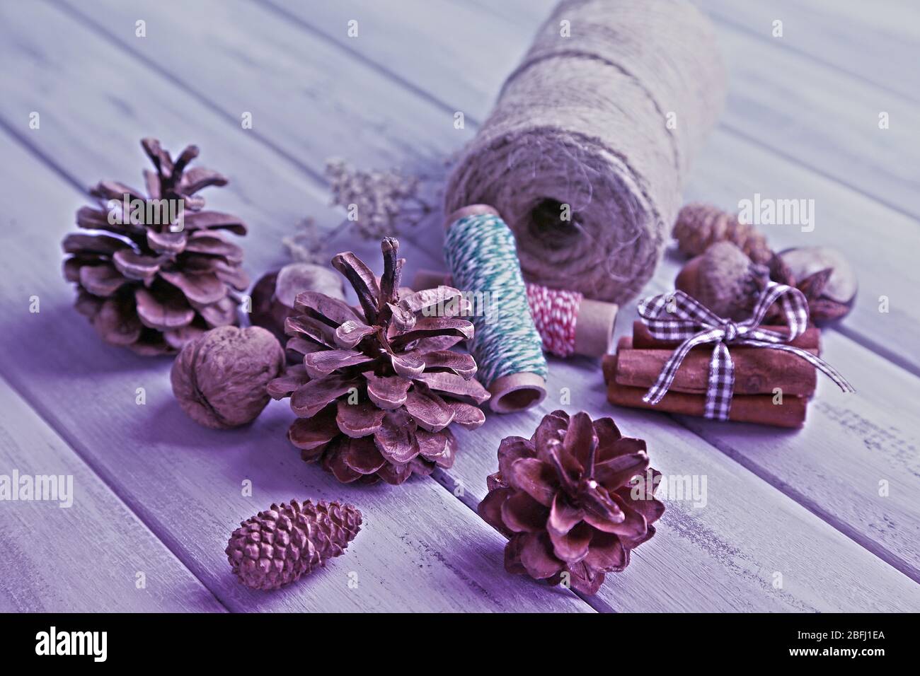 Composition with natural bump, thread, cinnamon sticks on wooden ...