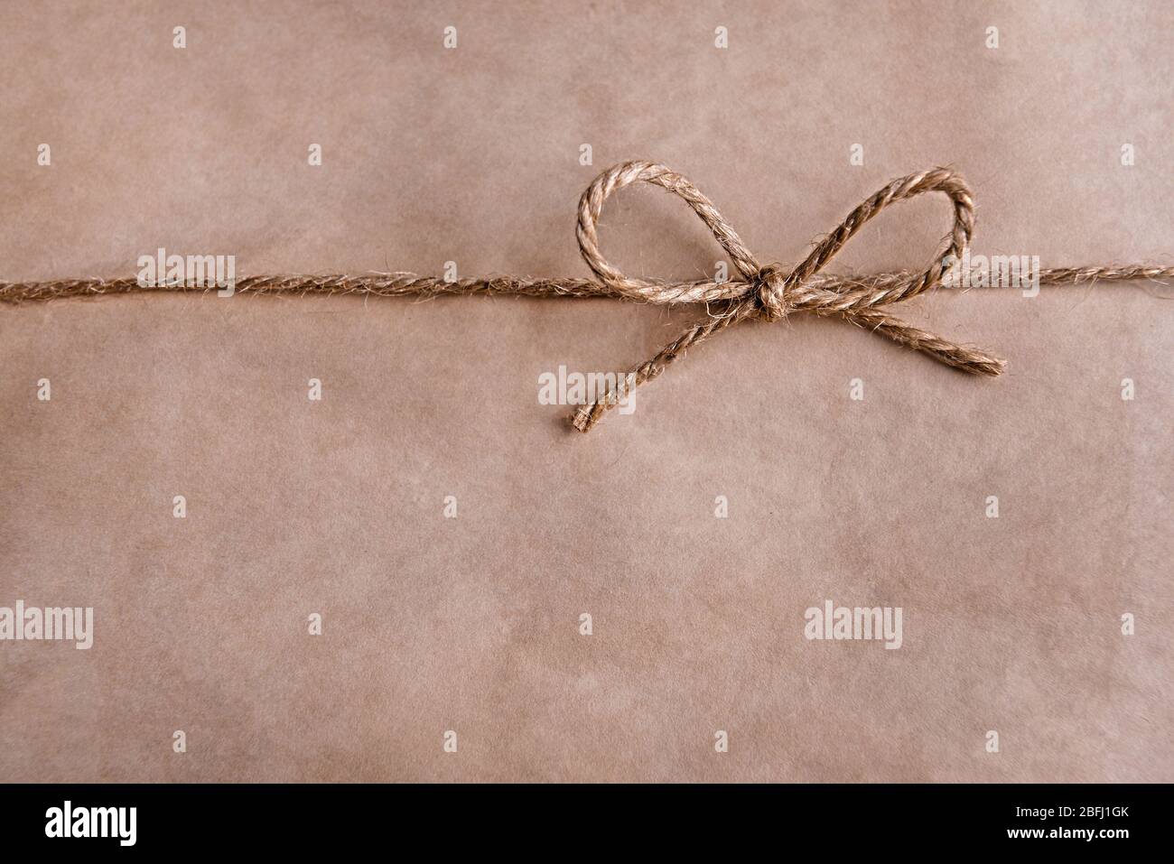 Paper texture with rope bow, close-up Stock Photo - Alamy