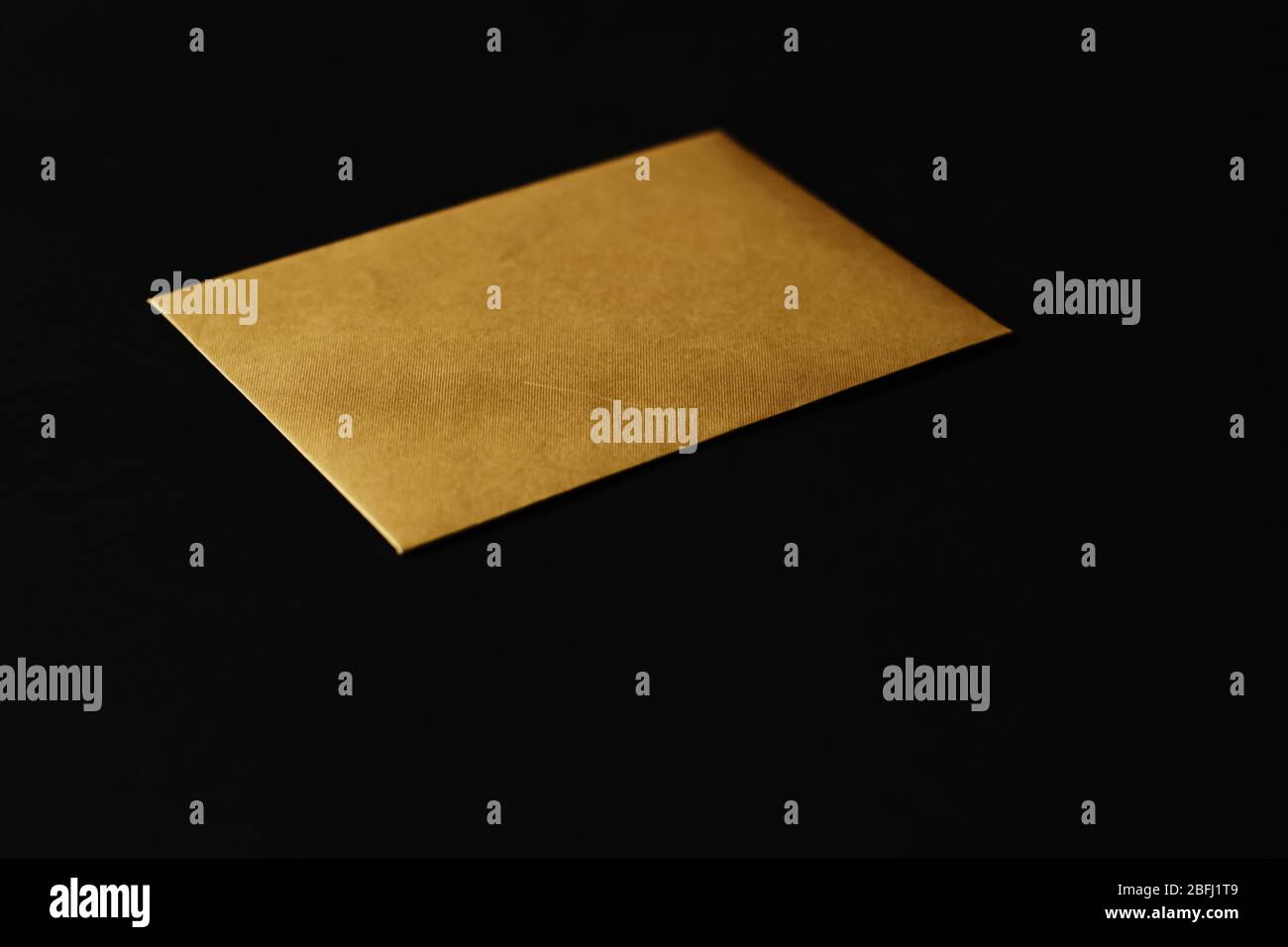 Blank golden paper card on black background, premium business and ...