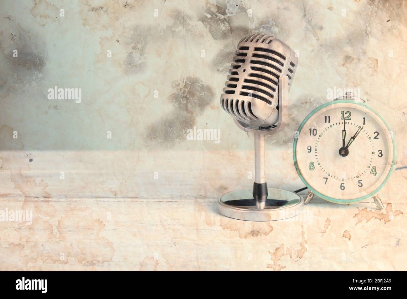 Vintage microphone and alarm clock on table Stock Photo - Alamy