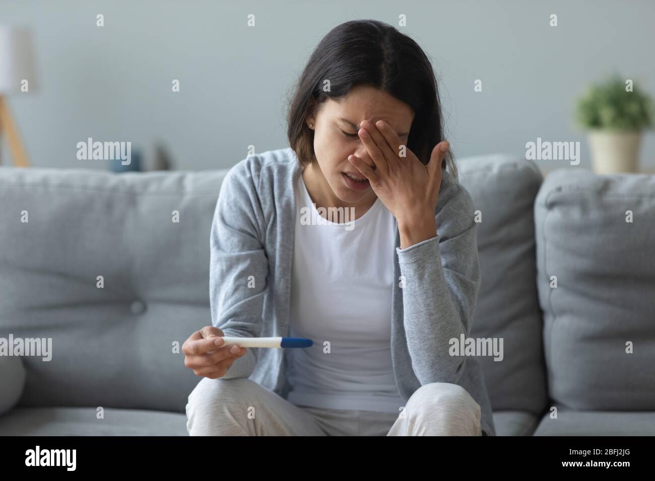 Unhappy Woman Dissatisfied By Pregnancy Test Result Touching Forehead