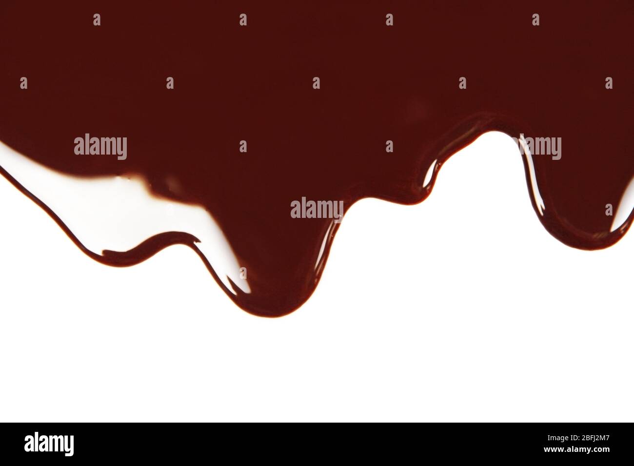 Melted chocolate dripping on white background Stock Photo - Alamy