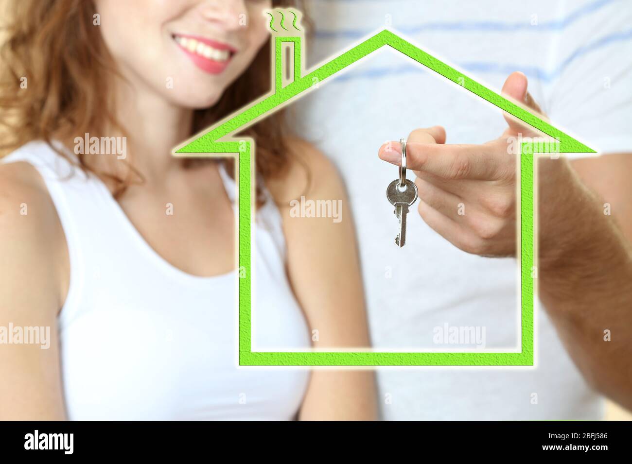 Loving couple with keys in drawing house Stock Photo - Alamy