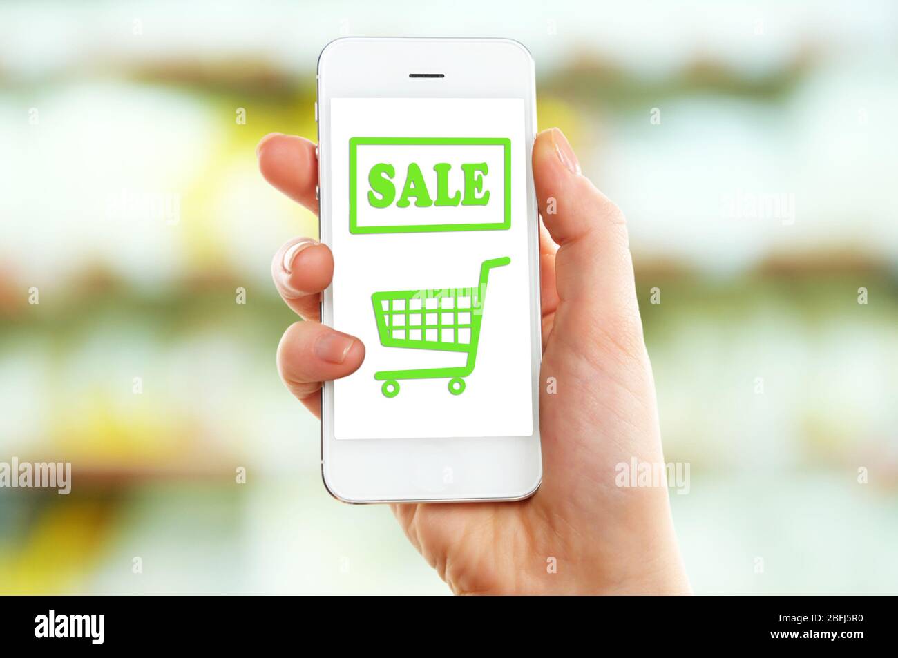 Mobile shopping concept. Hand holding mobile phone for internet ...