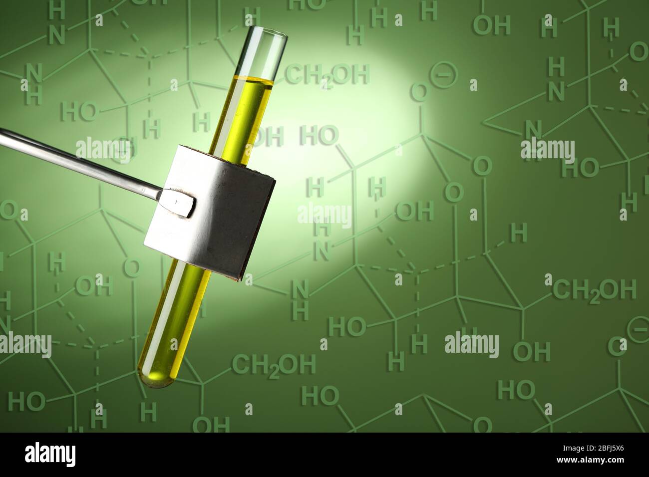 Laboratory test tube filled color liquid held in specialized clamp ...