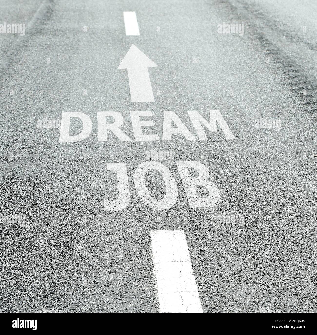 Text Dream Job with arrow marking on road surface Stock Photo - Alamy