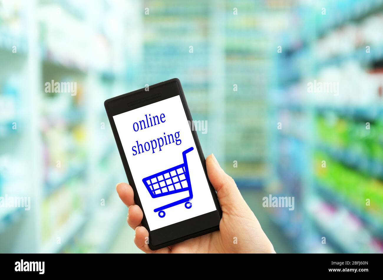 Mobile shopping concept. Hand holding mobile phone for internet ...