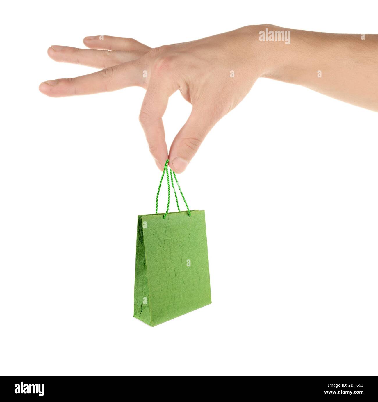 Small paper bag in big hand isolated on white Stock Photo - Alamy