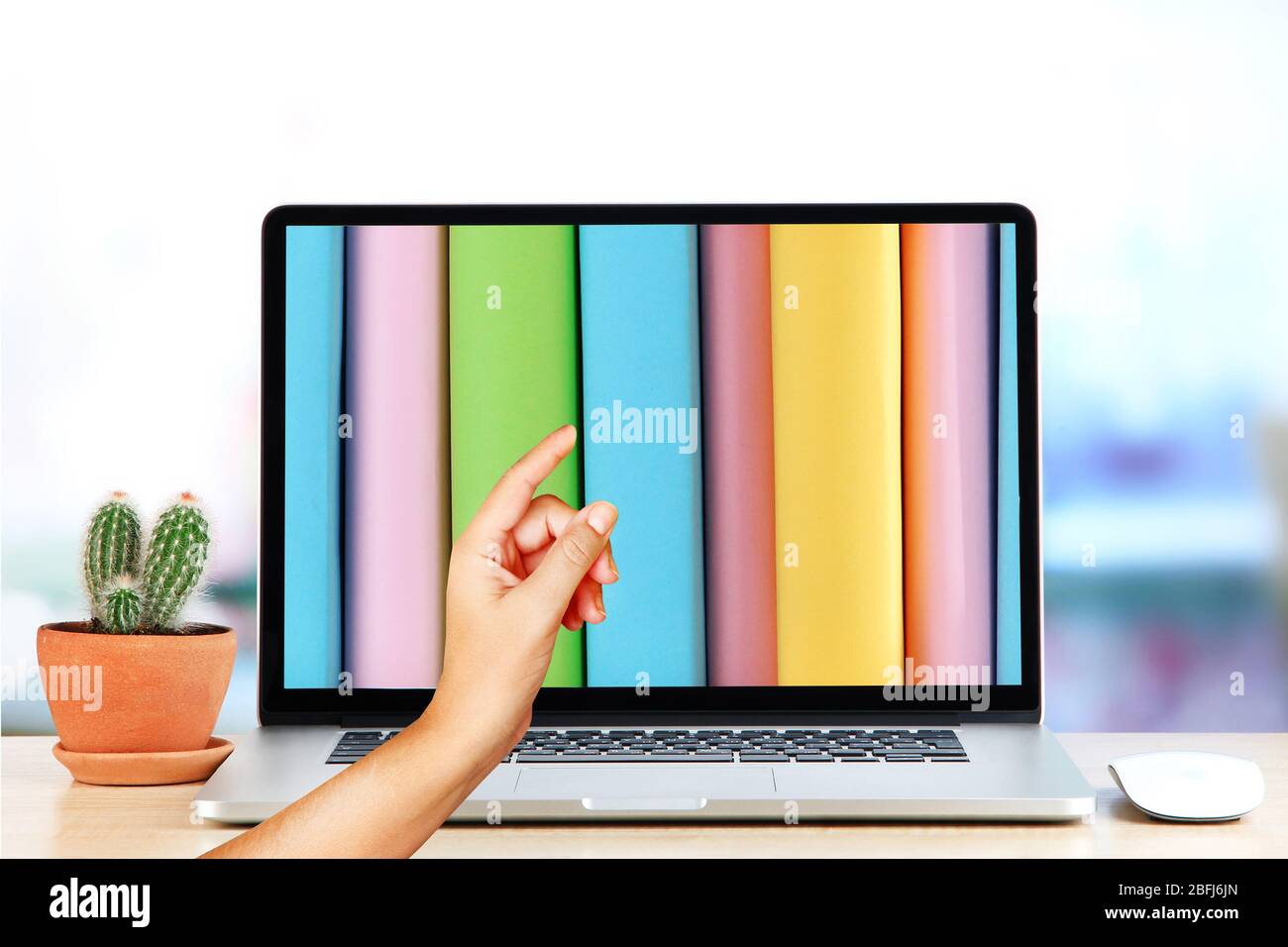 E-learning concept. Digital library - books inside laptop Stock Photo ...