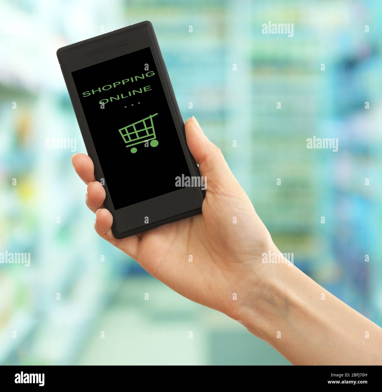 Mobile shopping concept. Hand holding mobile phone for internet ...