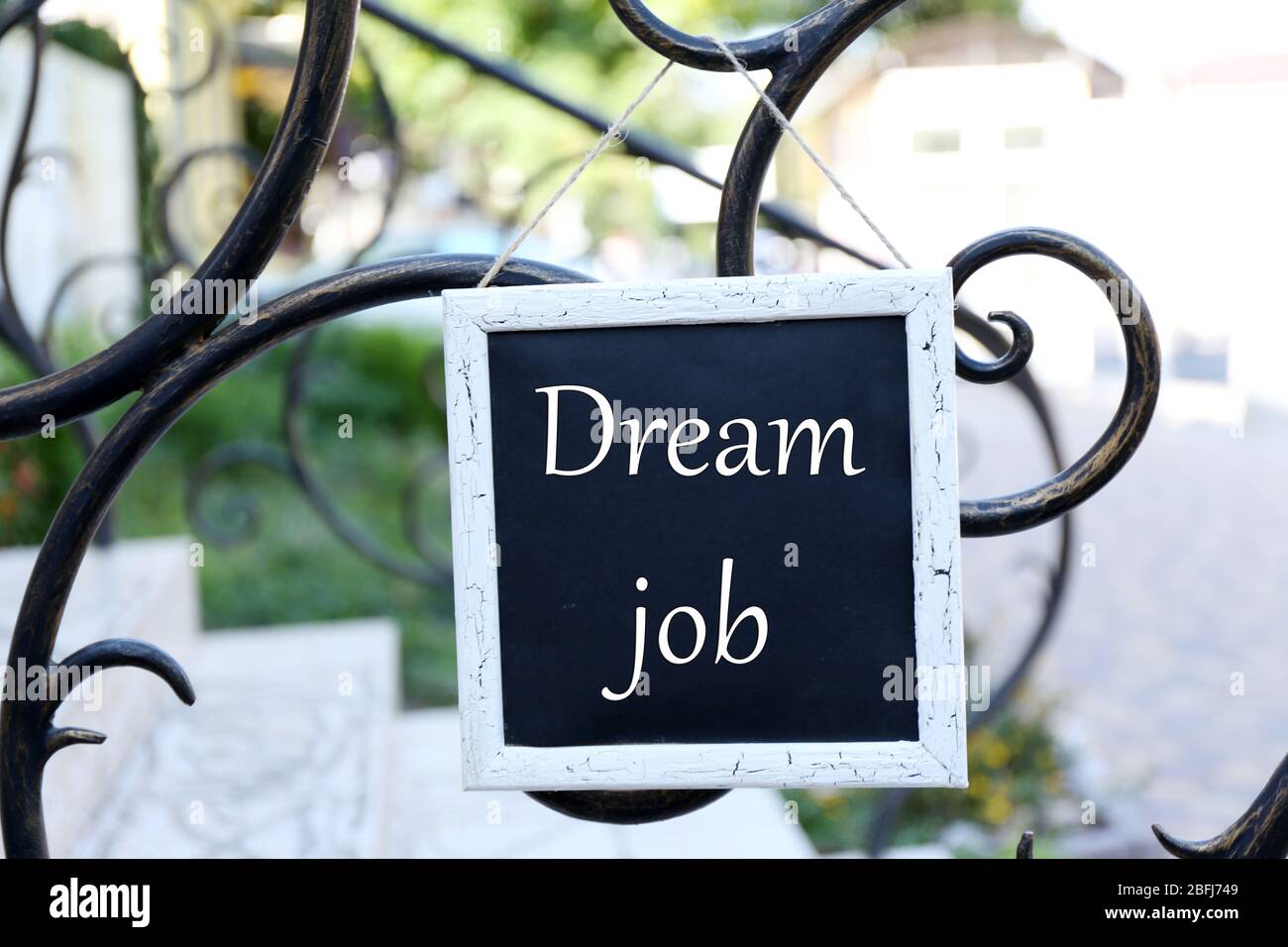 Signboard with Dream Job text on it hanging on metal fence Stock Photo ...