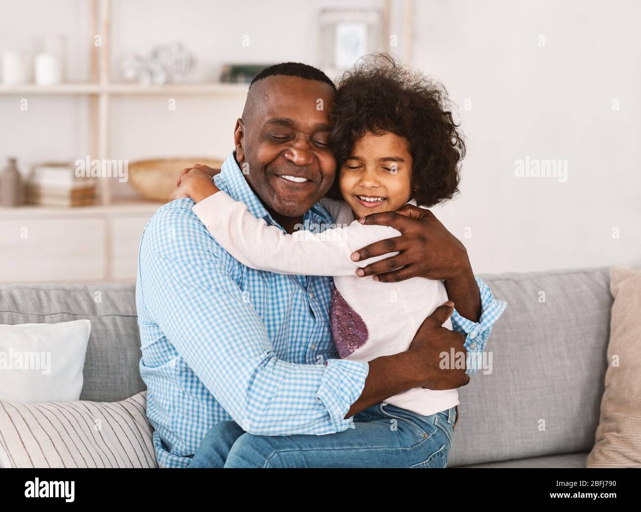 Stay at home, be happy. African American grandpa hugging his lovely ...