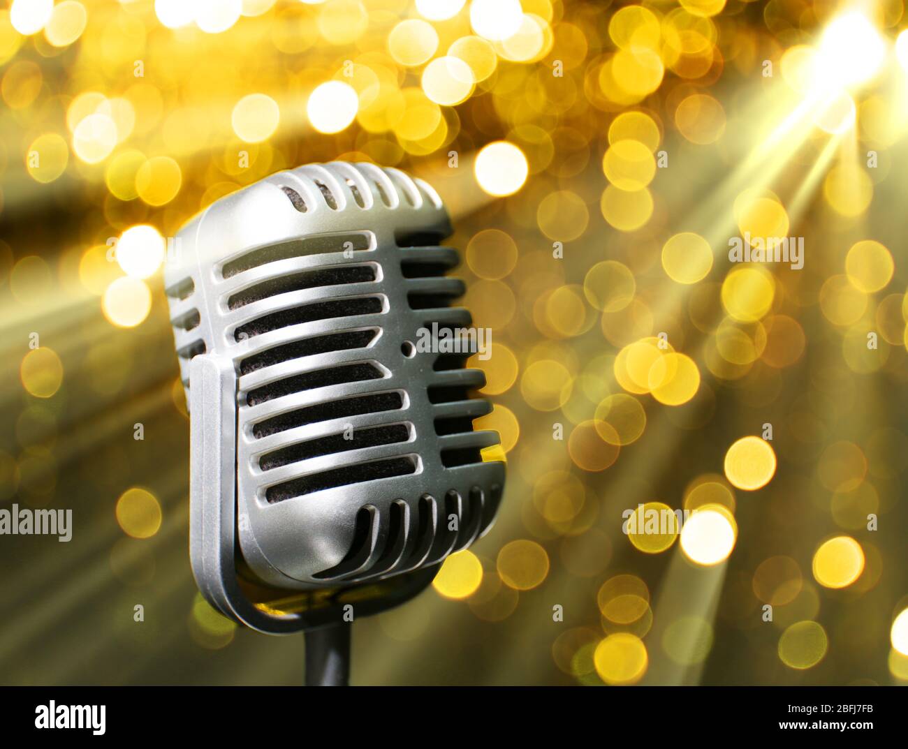 Silver retro microphone on golden festive background Stock Photo - Alamy