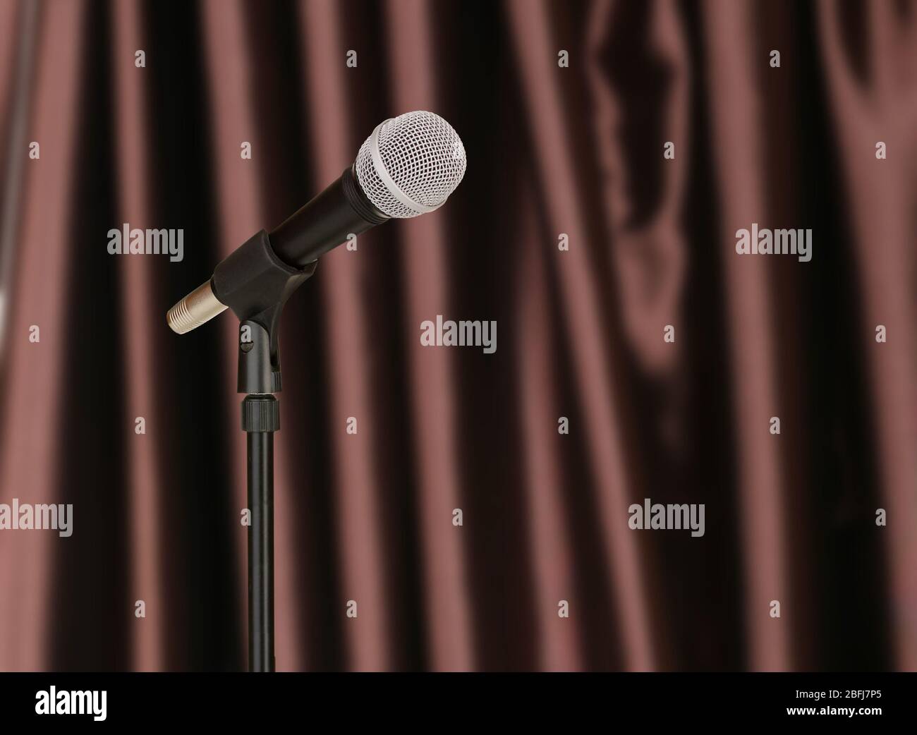 Microphone on brown curtain background Stock Photo - Alamy