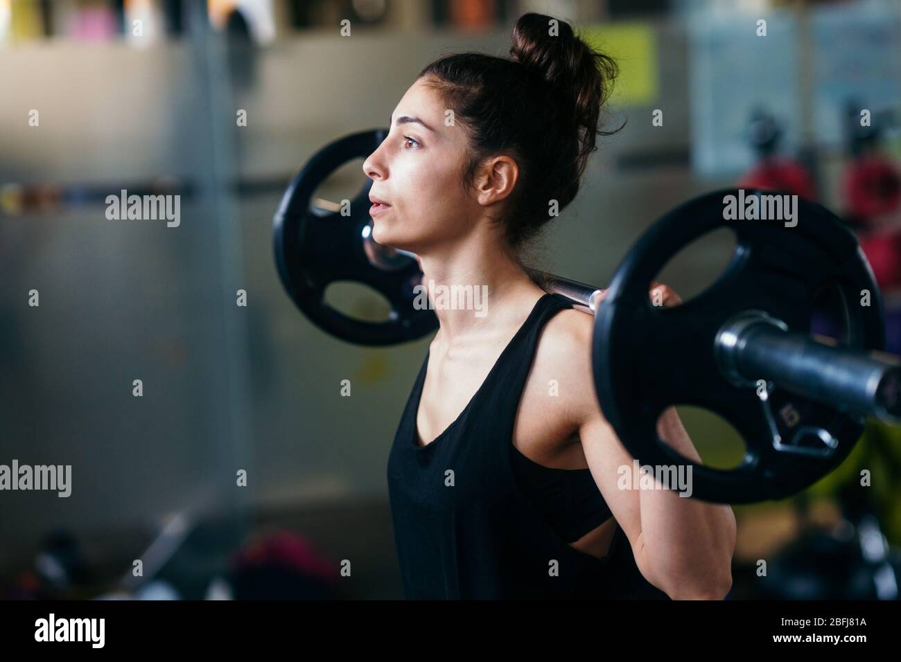 Athletic woman in gym lifting weights at the gym Stock Photo - Alamy