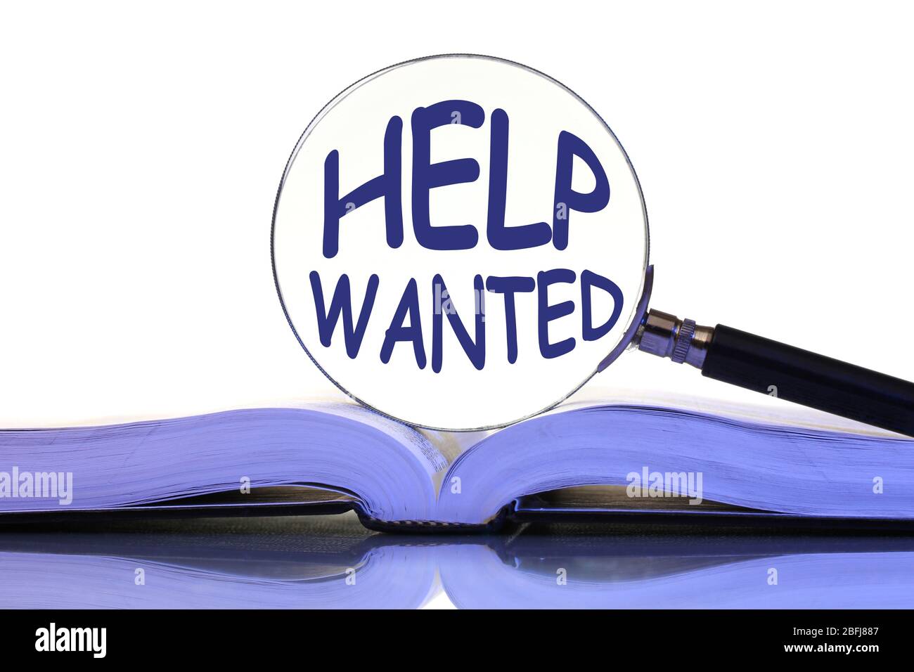 Magnifying glass and Help Wanted text on open book isolated on white ...
