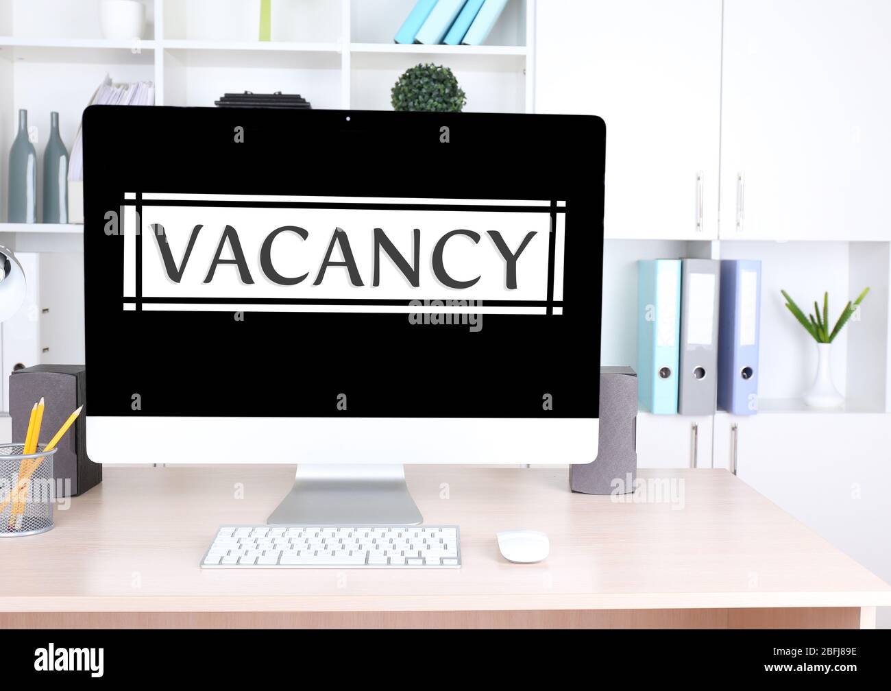 Office workplace with vacancy sign Stock Photo - Alamy