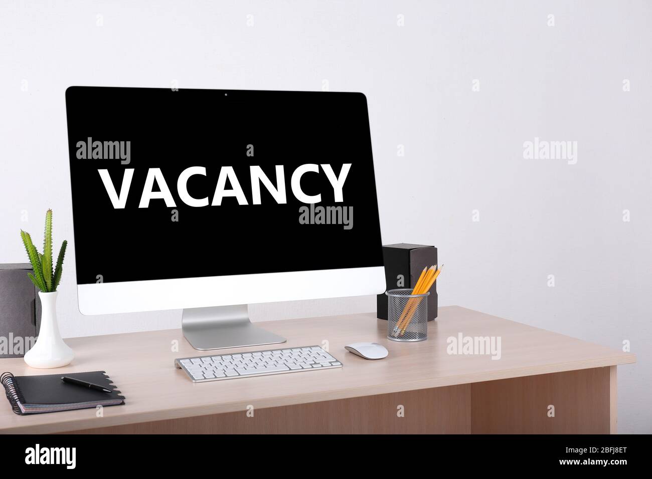 Office workplace with vacancy sign Stock Photo - Alamy