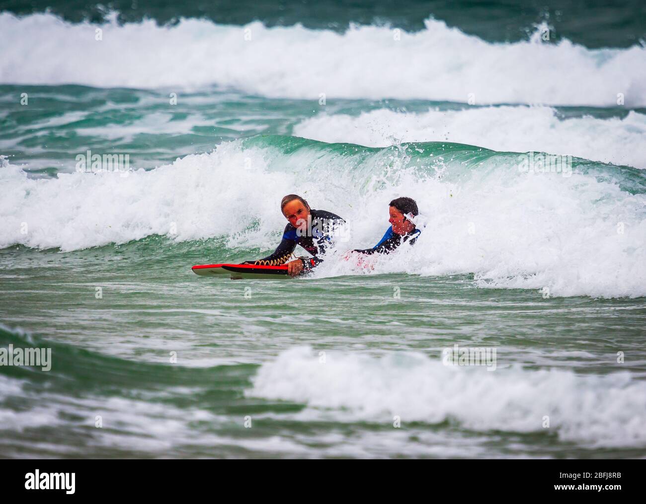 Cornish Surfers enjoying the white waters Stock Photo - Alamy