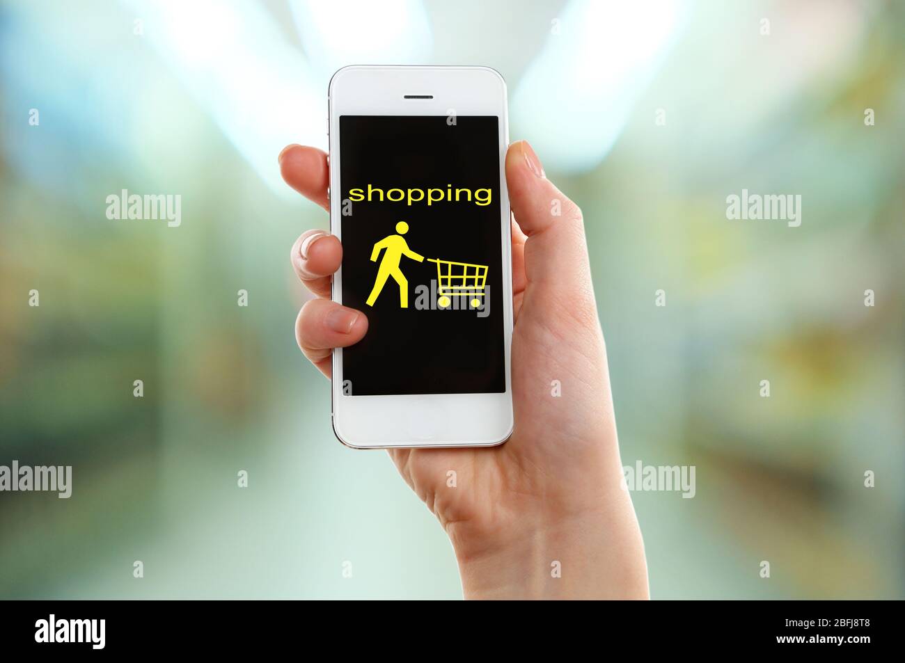 Mobile shopping concept. Hand holding mobile phone for internet ...