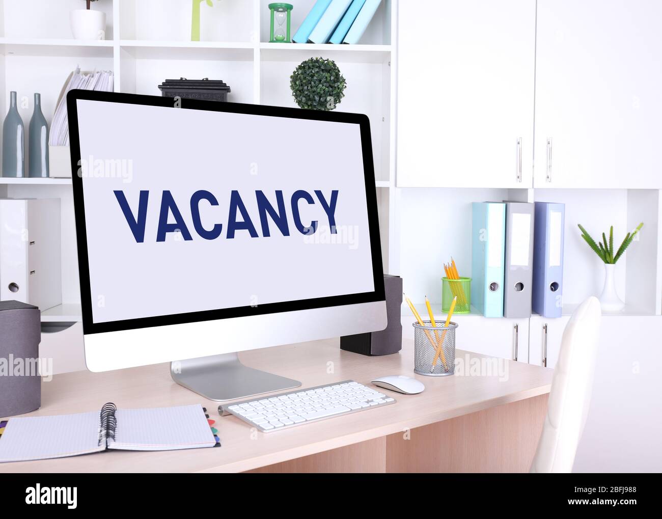 Office workplace with vacancy sign Stock Photo - Alamy