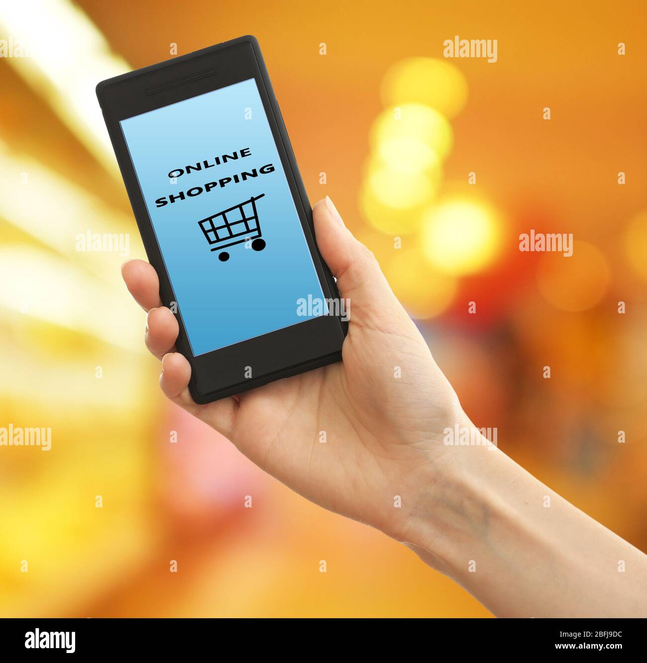 Mobile shopping concept. Hand holding mobile phone for internet ...