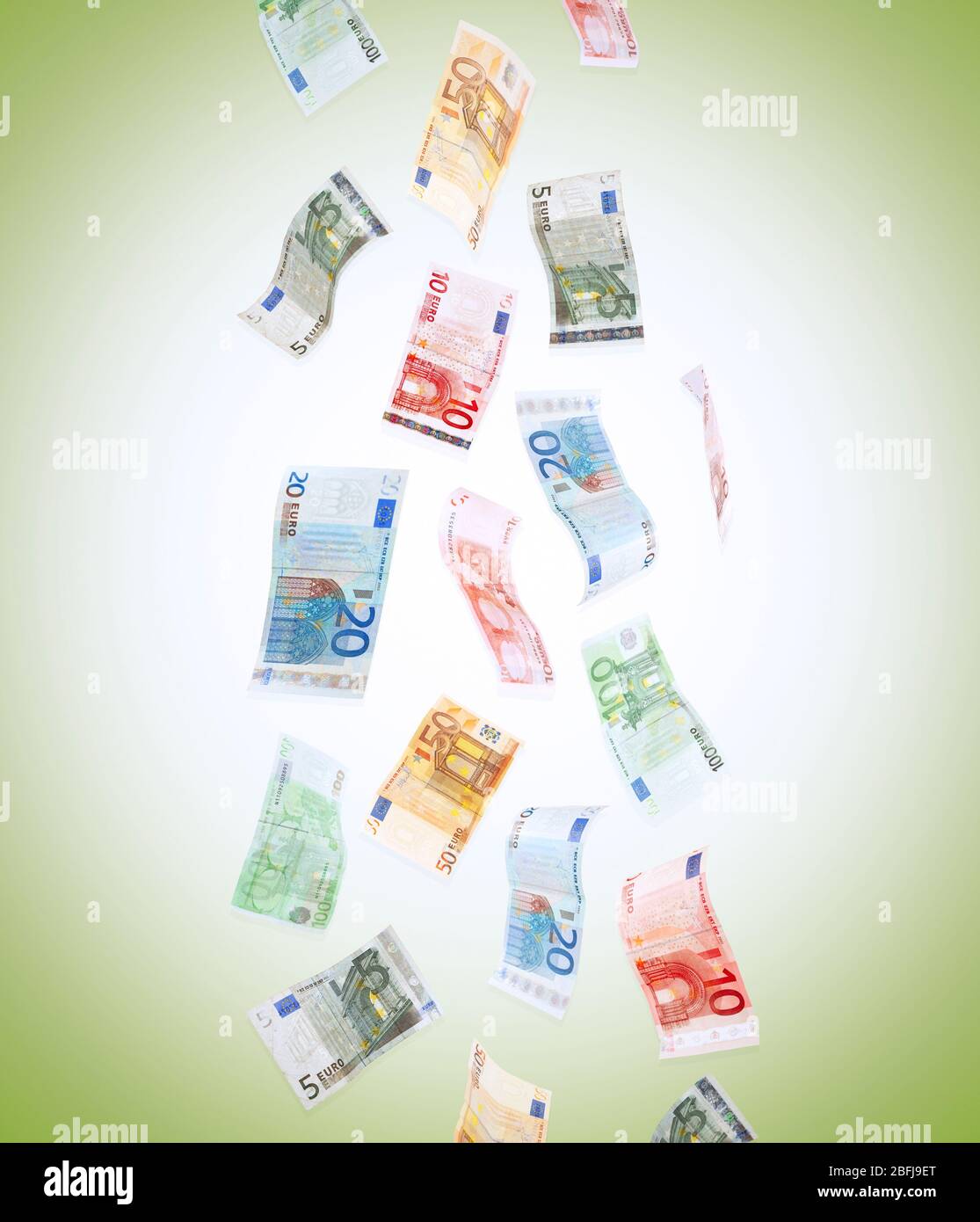 Flying Euro banknotes on green background Stock Photo - Alamy