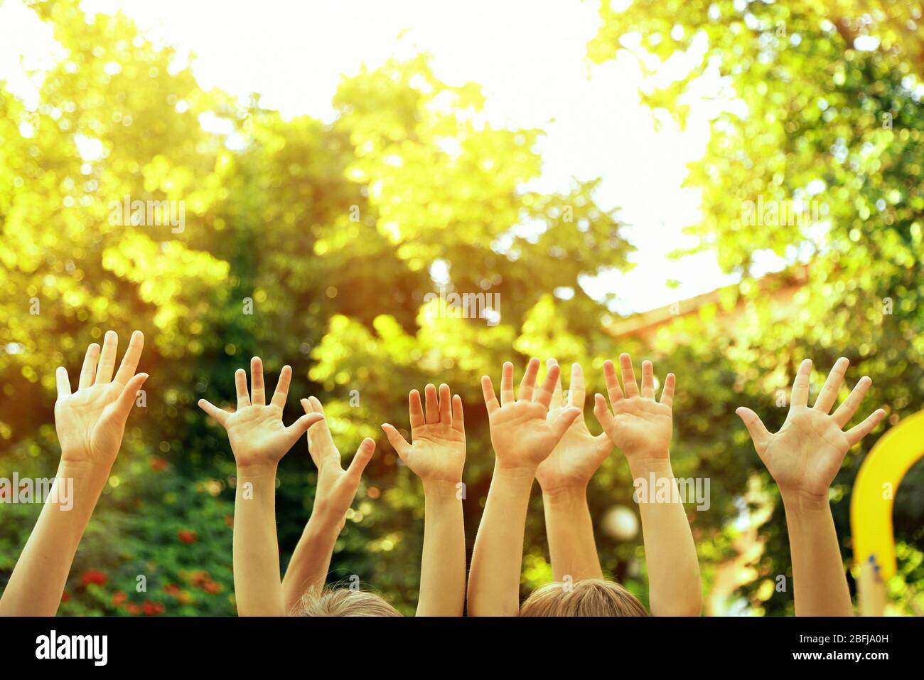 People hands up on sunny nature background Stock Photo - Alamy