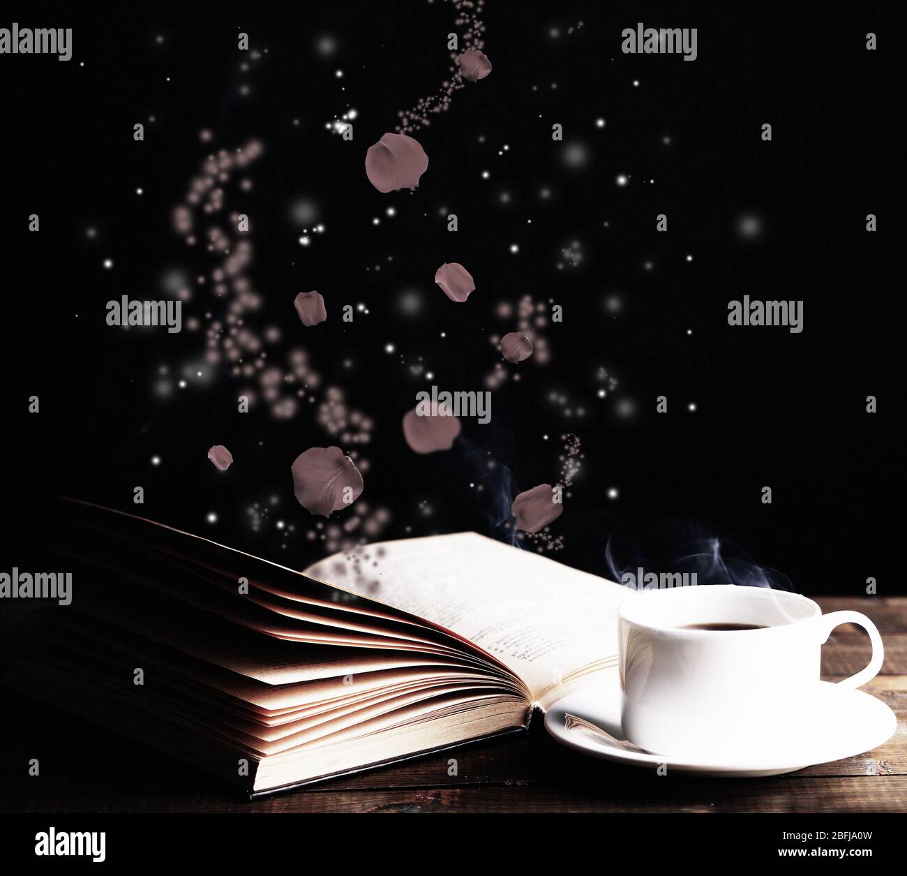 Open book with falling petals on table on dark background Stock Photo ...