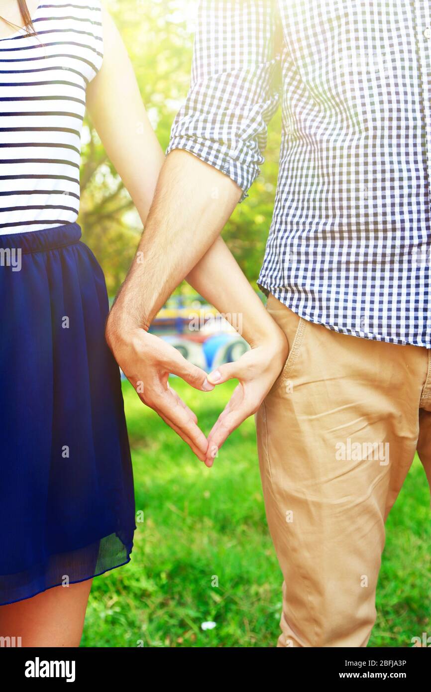 Loving couple holding hands outdoors on sunny nature background Stock ...