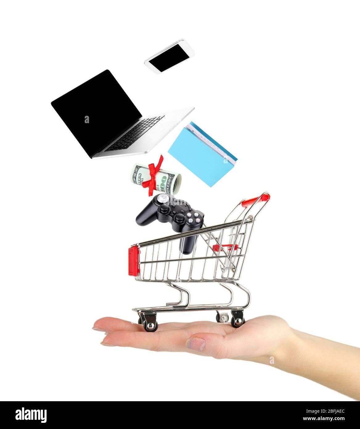 Goods falling into cart isolated on white Stock Photo - Alamy