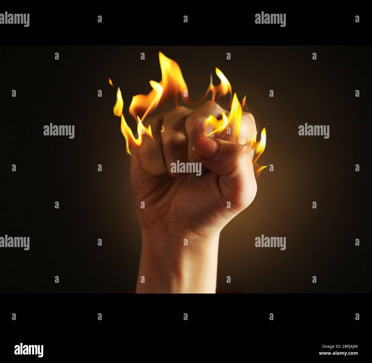 Burning fist isolated on black Stock Photo - Alamy