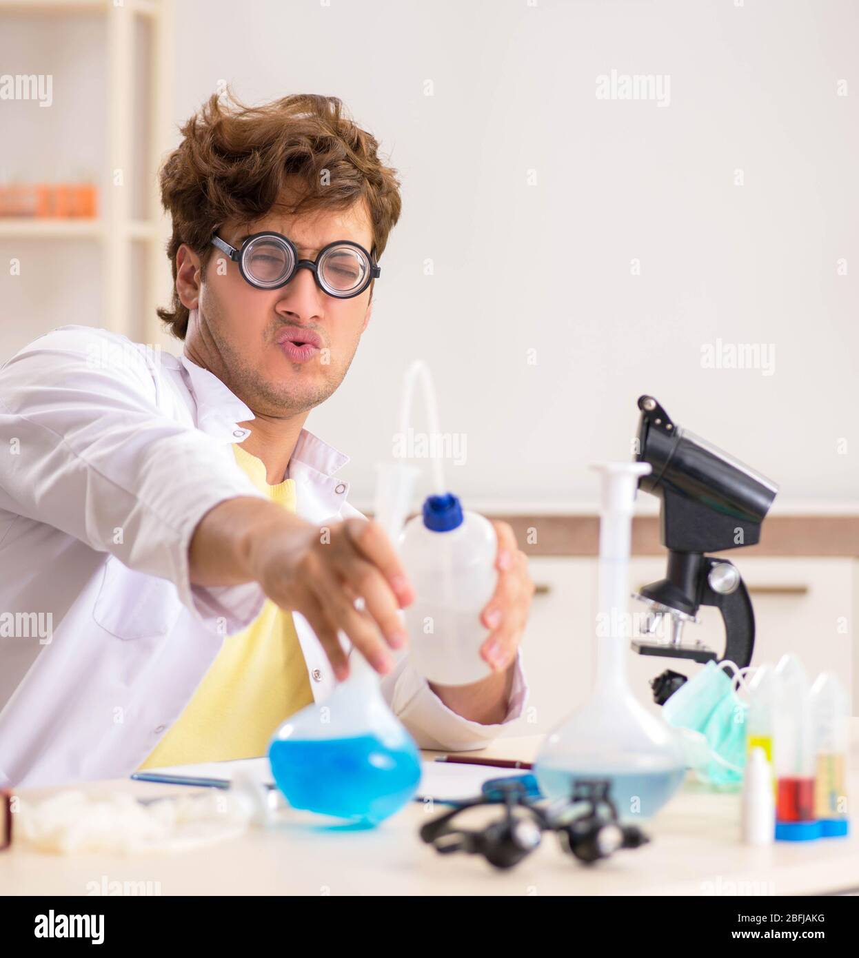The funny crazy chemist doing experiments and tests Stock Photo - Alamy