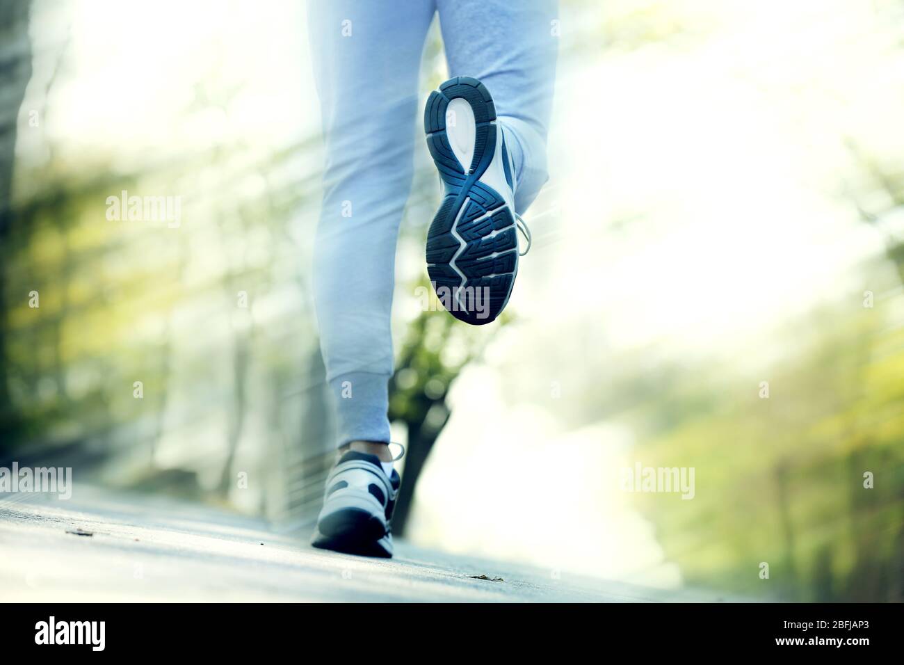Runner feet on road, outdoors Stock Photo - Alamy