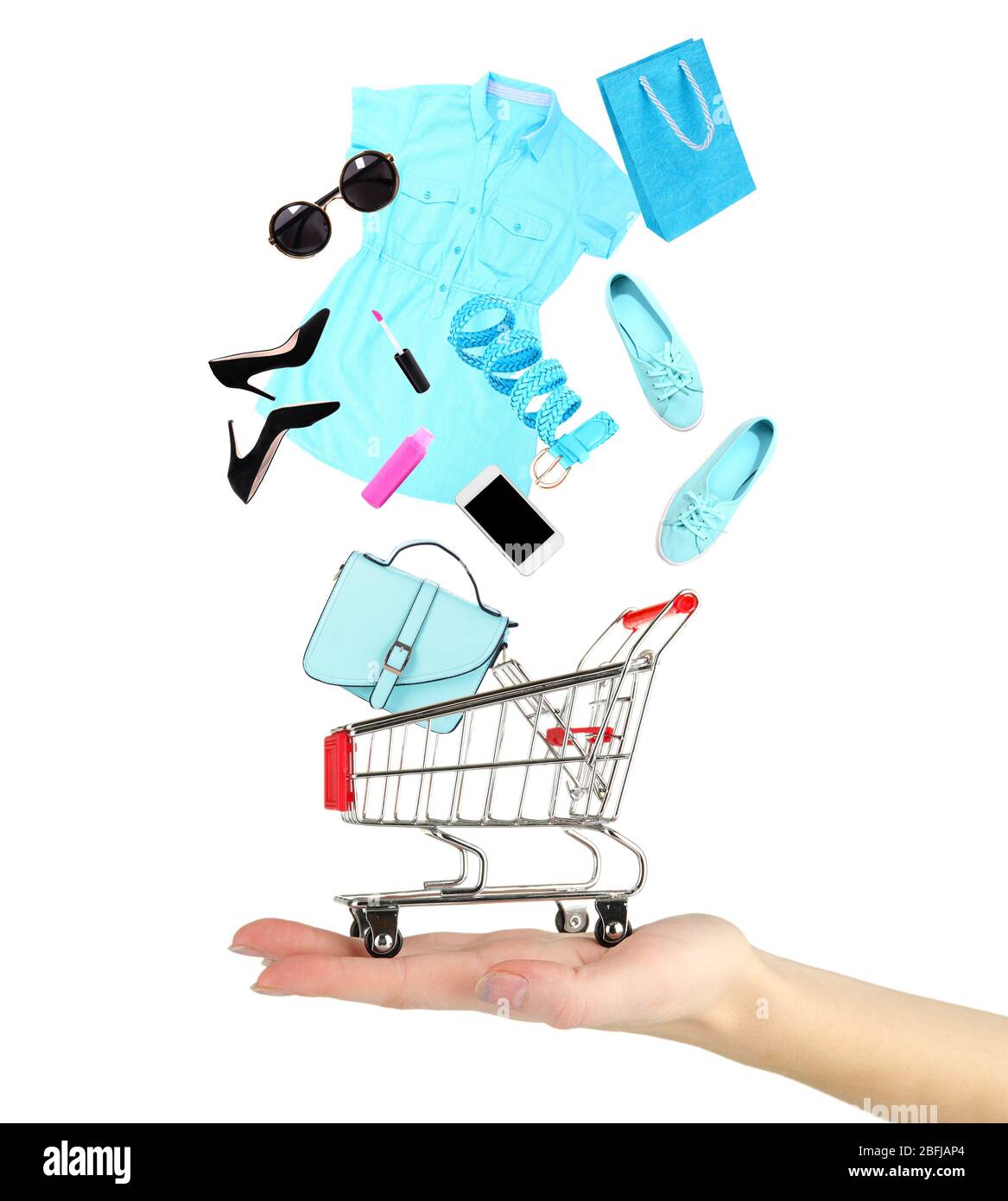 Goods falling into cart isolated on white Stock Photo - Alamy