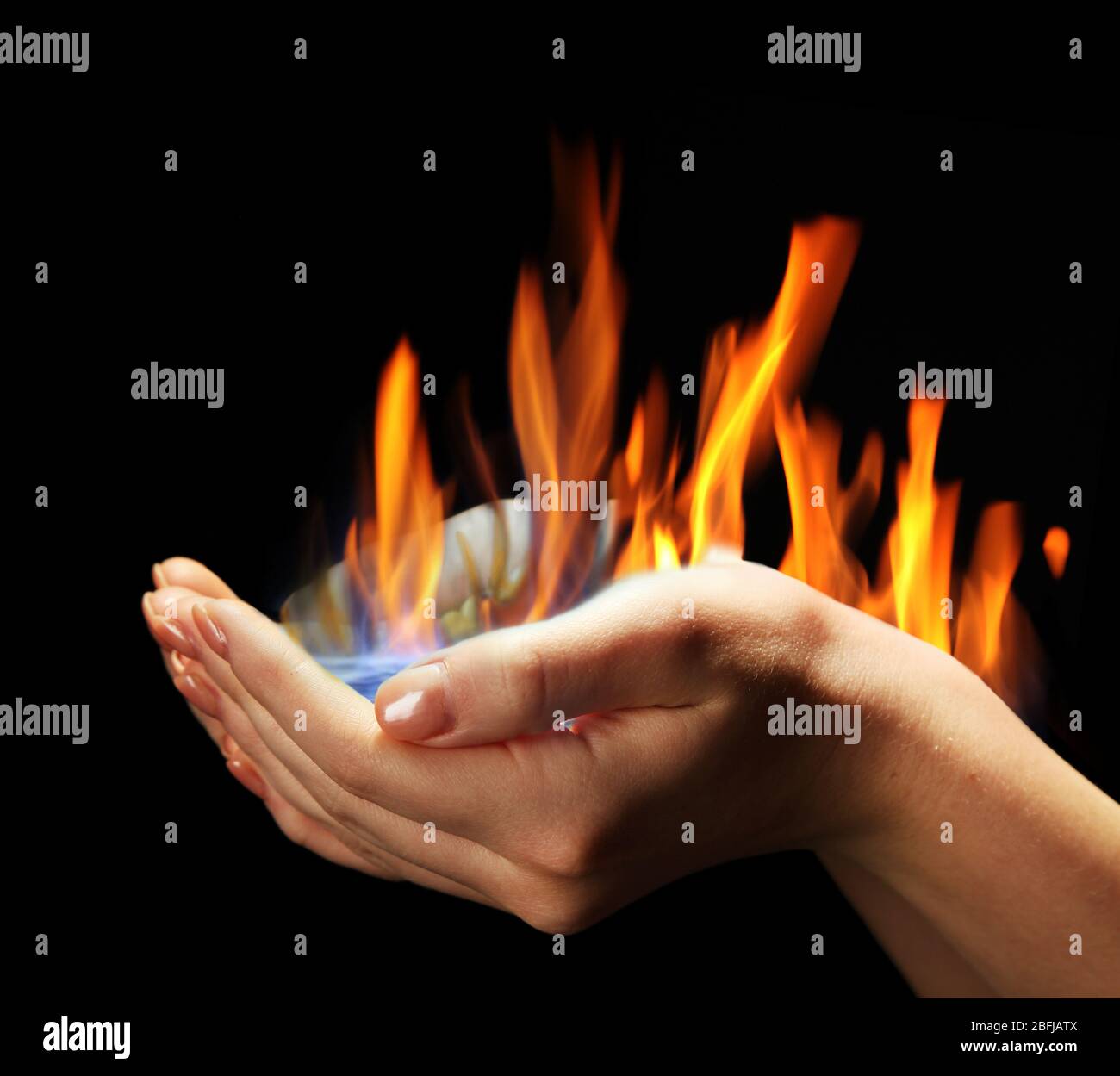 Hands with fire isolated on black Stock Photo - Alamy